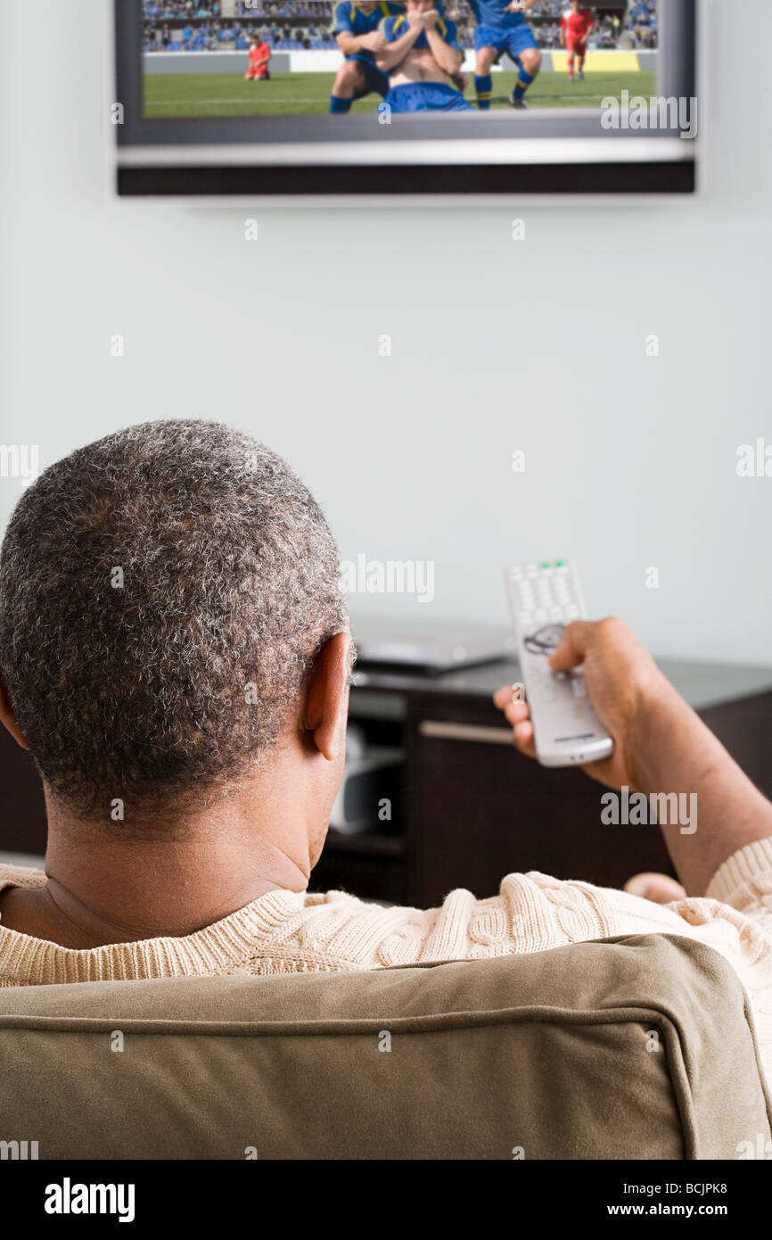 Man watching television Stock Photo - Alamy