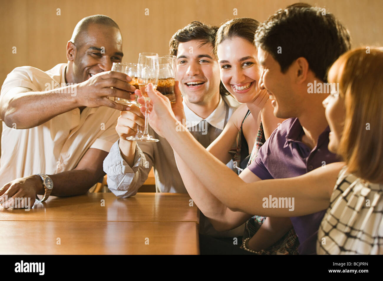 Friends celebrating in a bar Stock Photo - Alamy