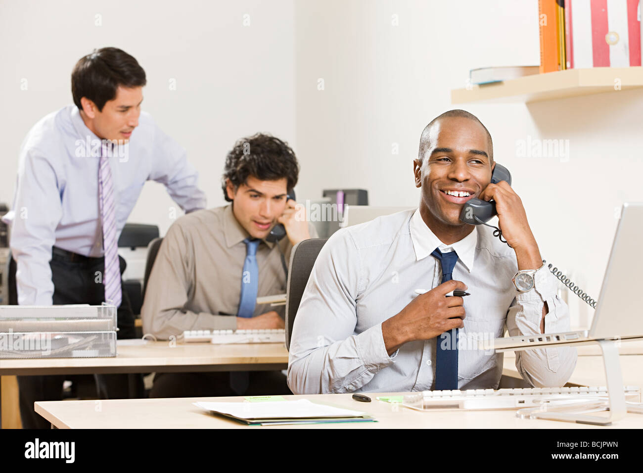 Three male office workers hi-res stock photography and images - Alamy