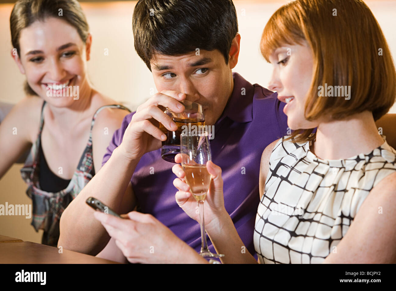 Three friends drinking in a bar Stock Photo - Alamy