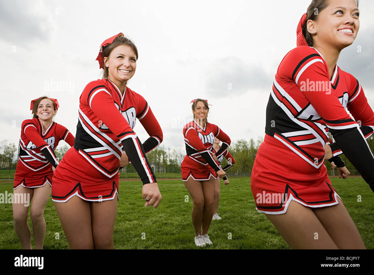 Cheerleaders performing routine Stock Photo - Alamy