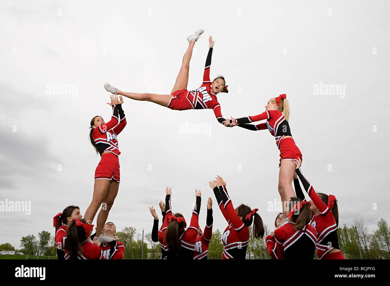 Cheerleaders performing routine Stock Photo - Alamy