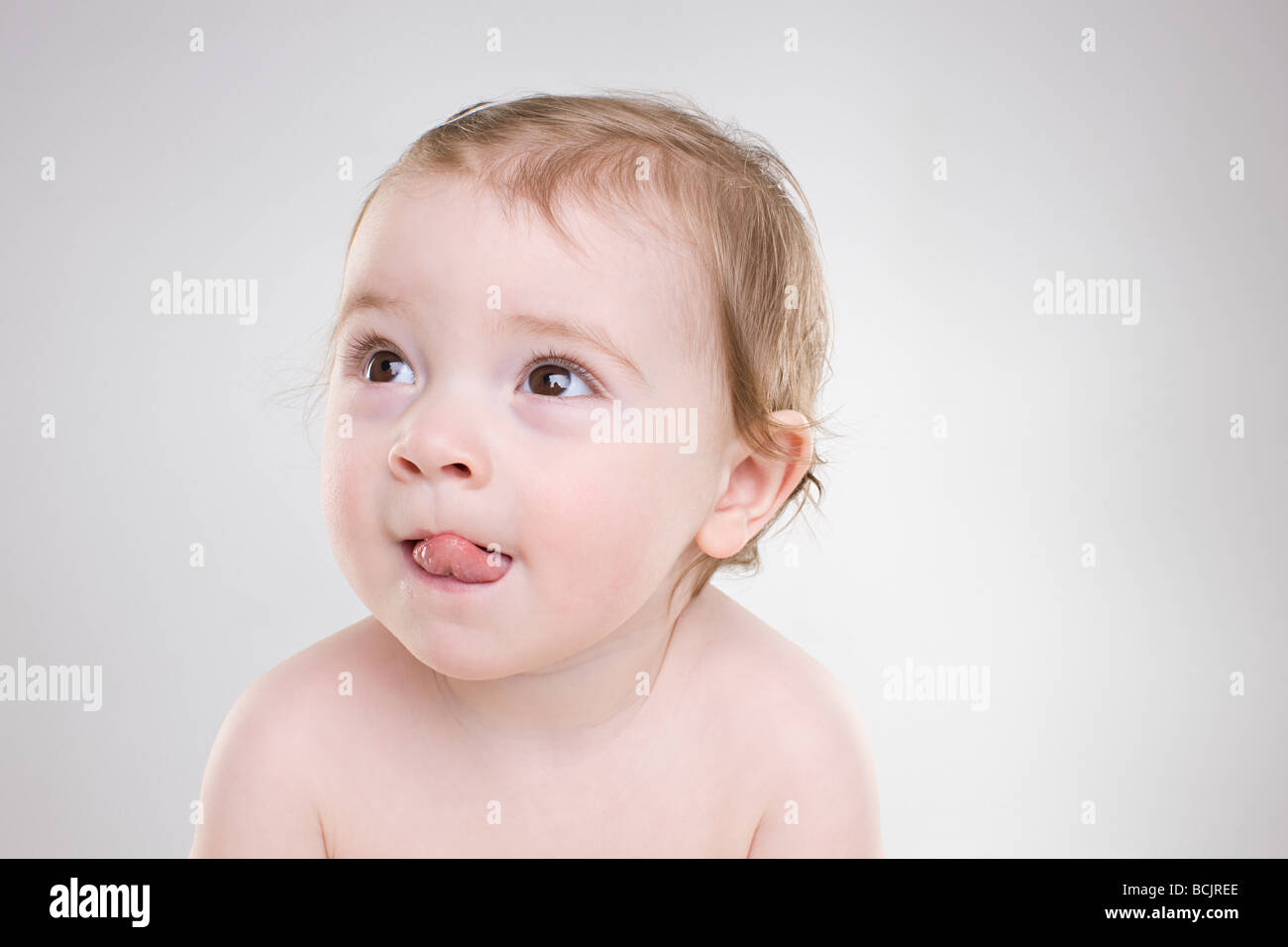 Baby sticking out tongue Stock Photo - Alamy