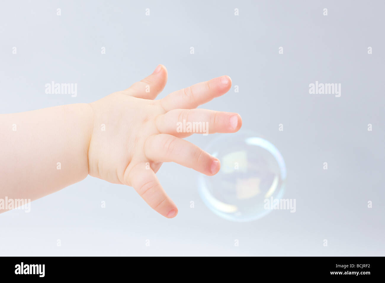 Hand of baby and bubble Stock Photo - Alamy
