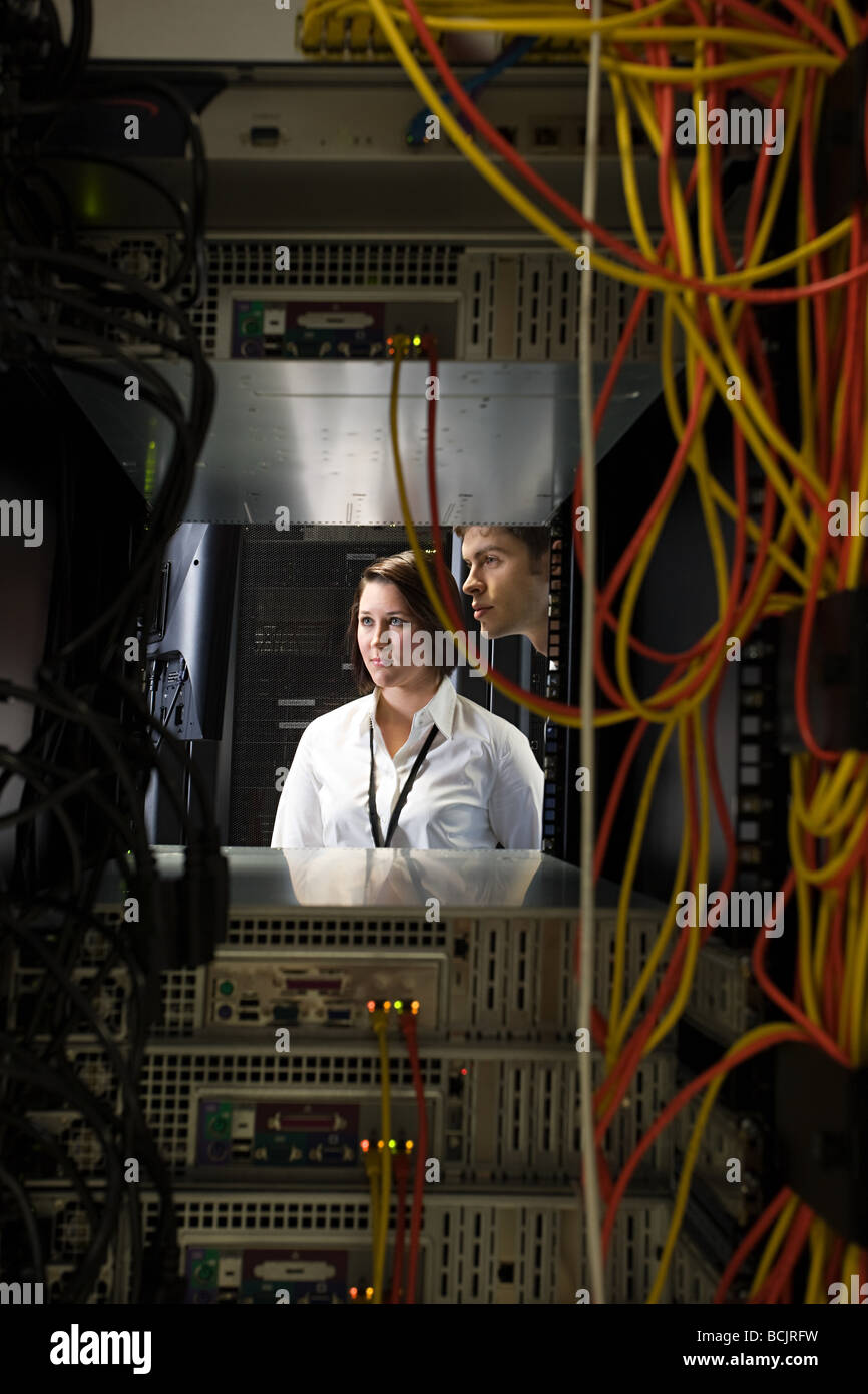 Two computer technicians and a network server Stock Photo - Alamy