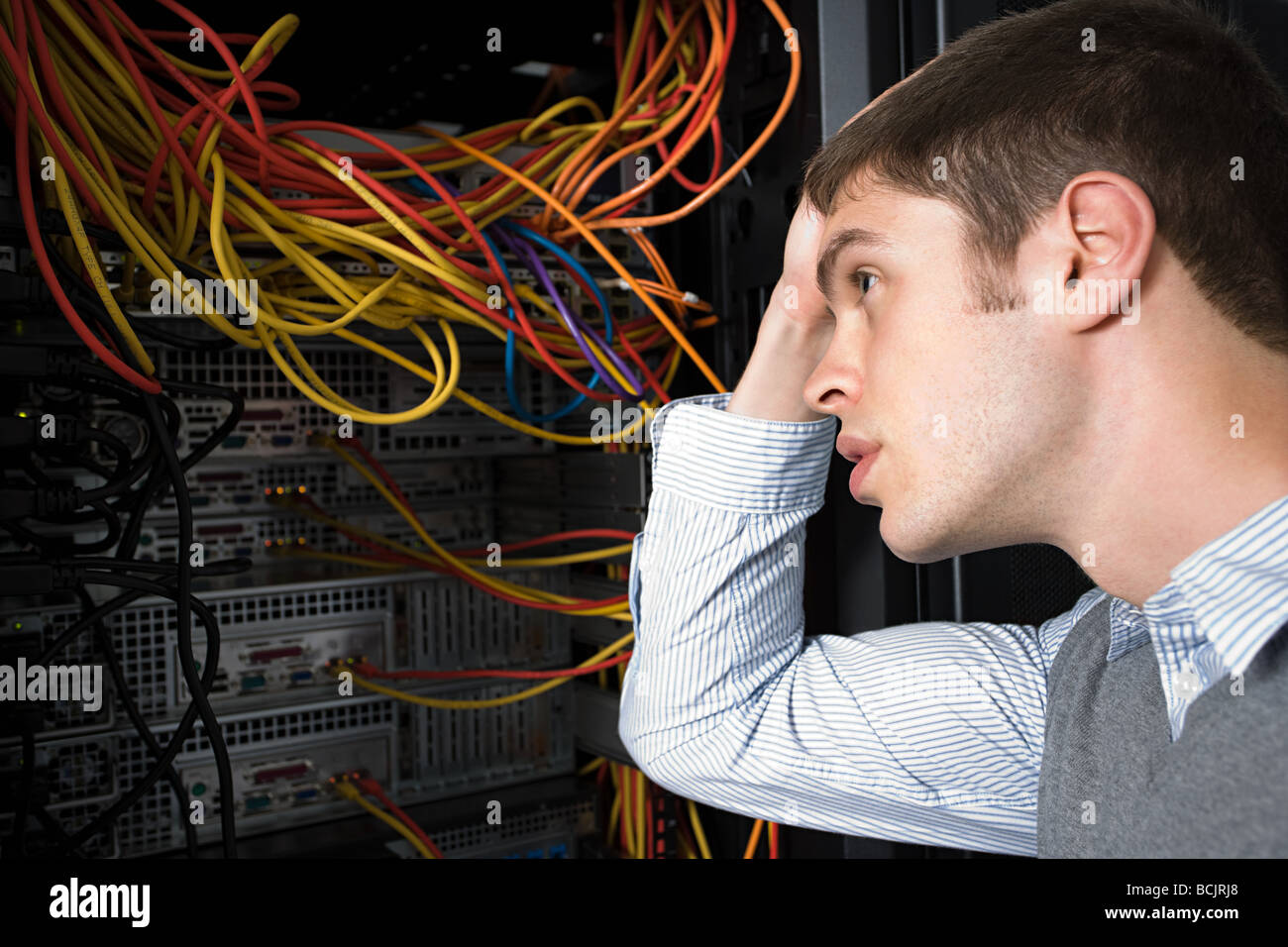 Confused looking computer technician Stock Photo - Alamy