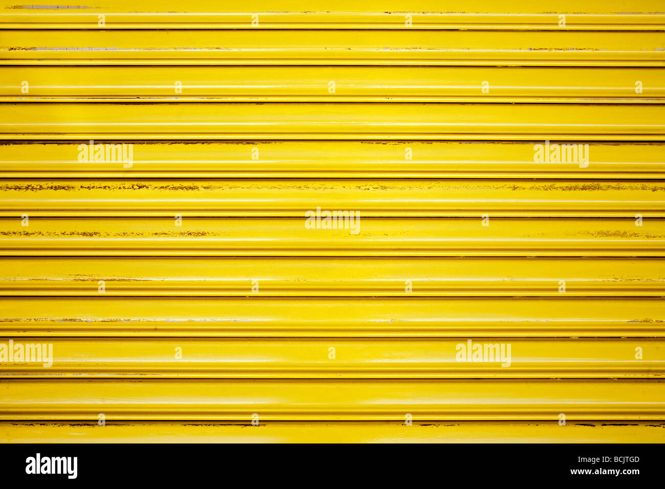 Closed yellow shutter Stock Photo - Alamy