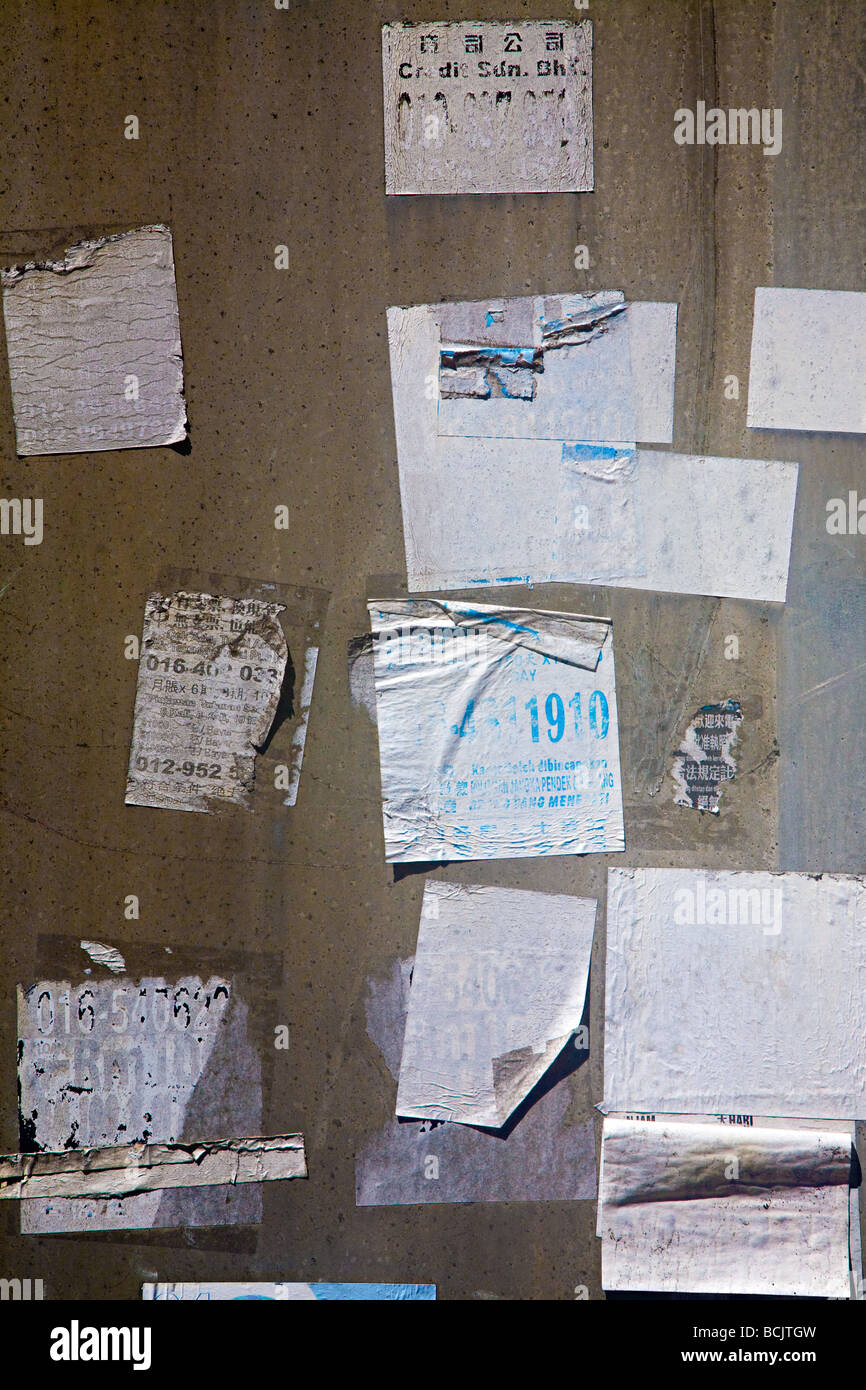 Torn stickers on a wall Stock Photo - Alamy