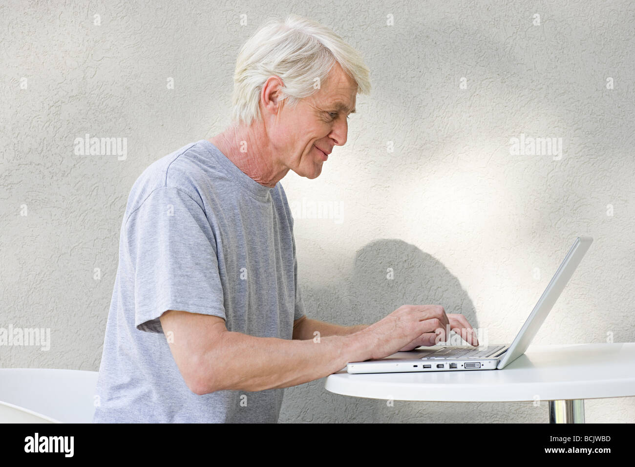 Middle aged man using laptop Stock Photo - Alamy