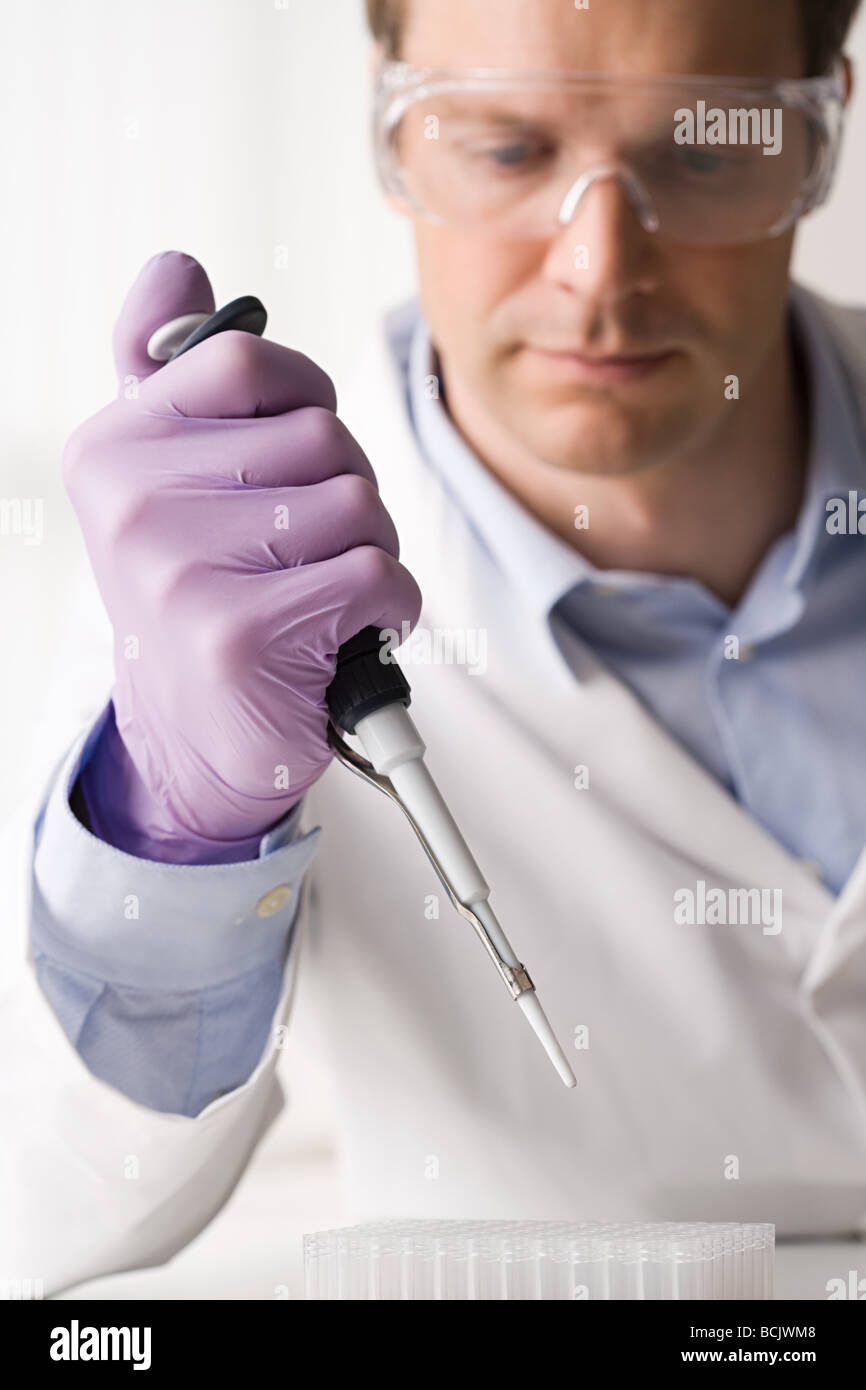 Male scientist doing an experiment Stock Photo - Alamy
