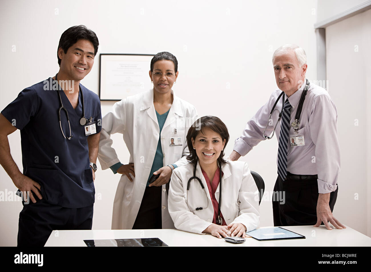 Group doctors sitting desk hi-res stock photography and images - Alamy