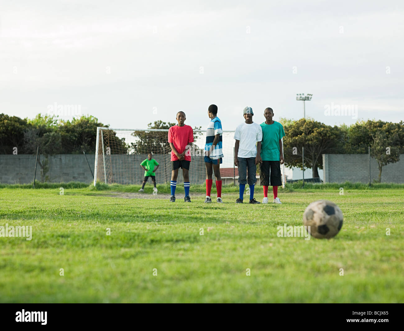 Teenage boys playing football Stock Photo - Alamy