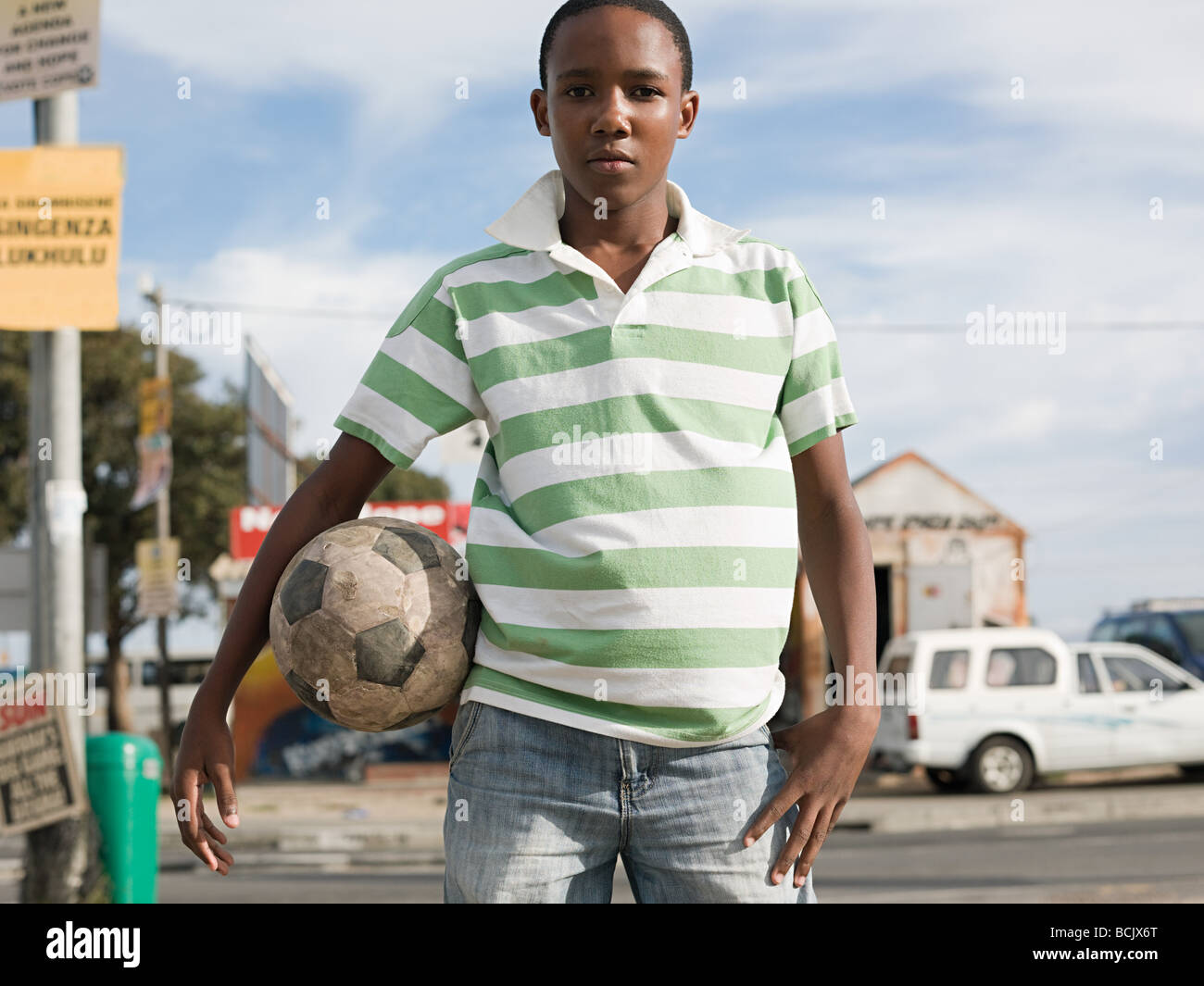 Teenage african boy with football Stock Photo - Alamy