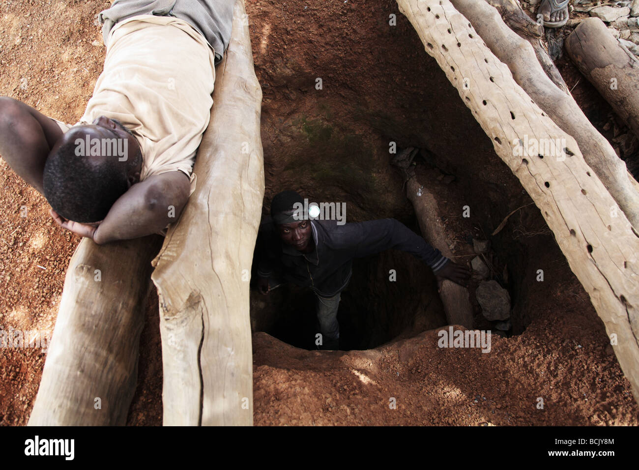 Mine shaft leading into deep and dangerous mine tunnels. A miner shows ...