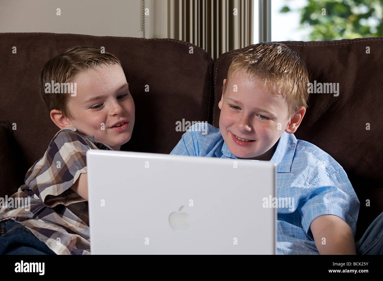 Two young boy using laptop computer at home Stock Photo - Alamy