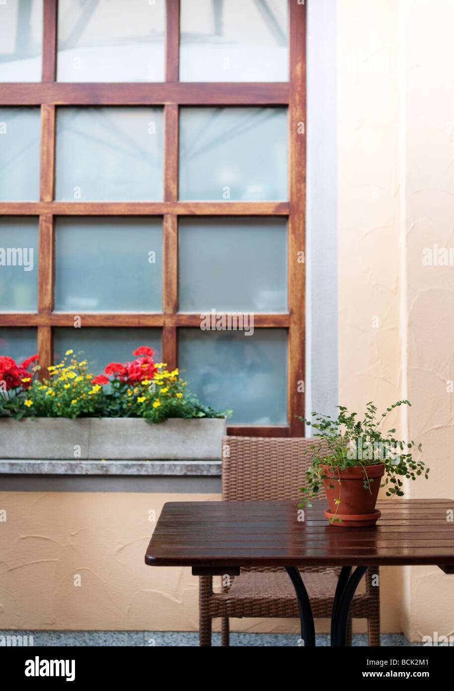 Chair with table and plants Stock Photo - Alamy