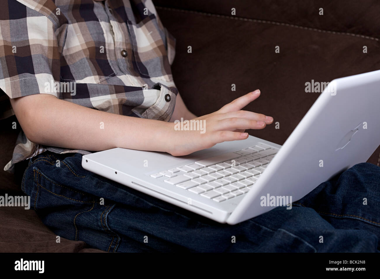 Young boy using laptop computer at home Stock Photo - Alamy