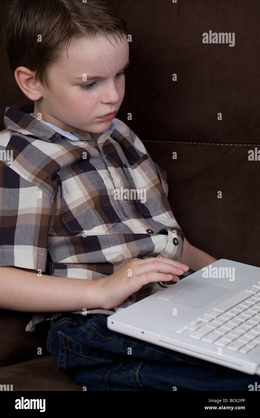 Young boy using laptop computer at home Stock Photo - Alamy