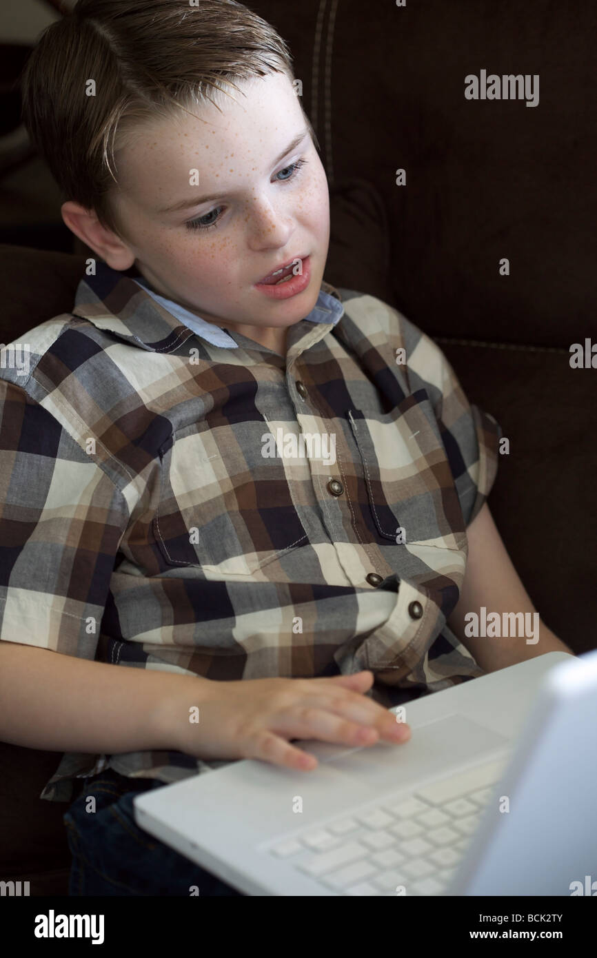 Young boy using laptop computer at home Stock Photo - Alamy