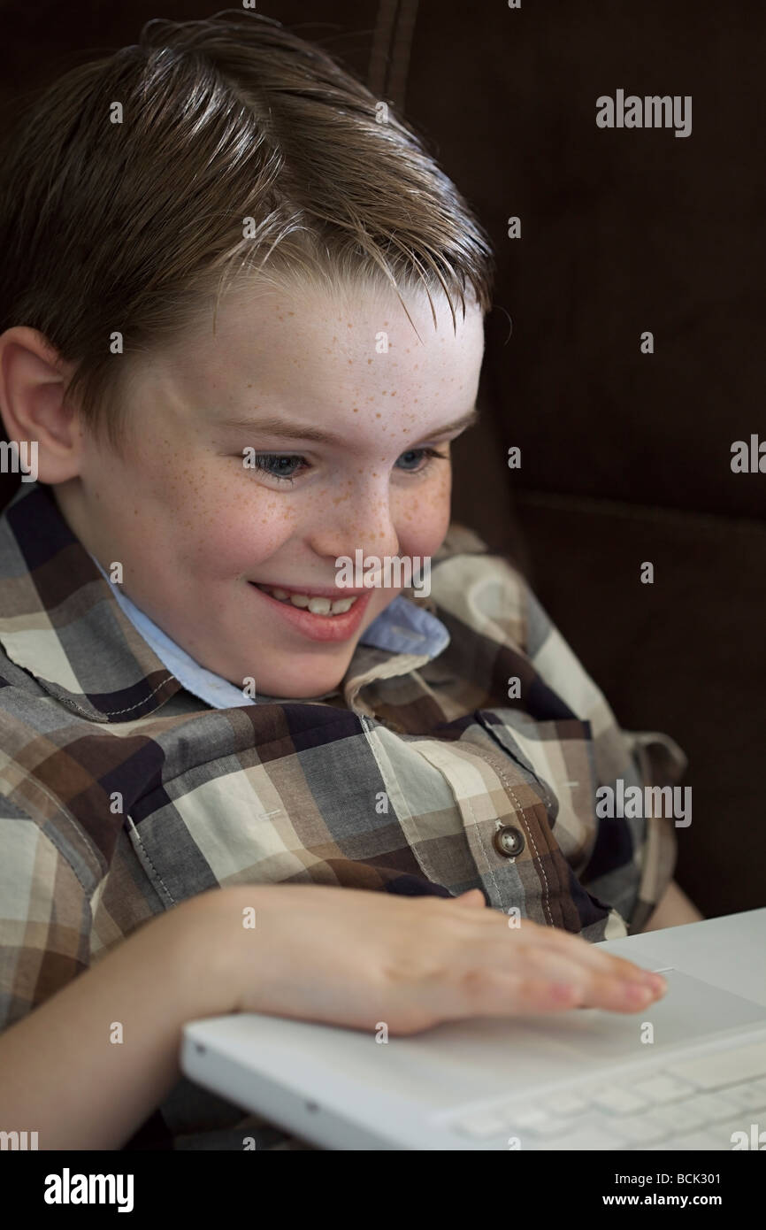 Young boy using laptop computer at home Stock Photo - Alamy
