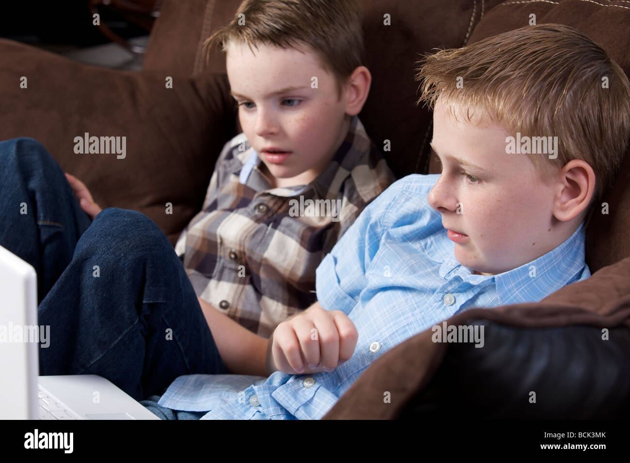Two young boy using laptop computer at home Stock Photo - Alamy