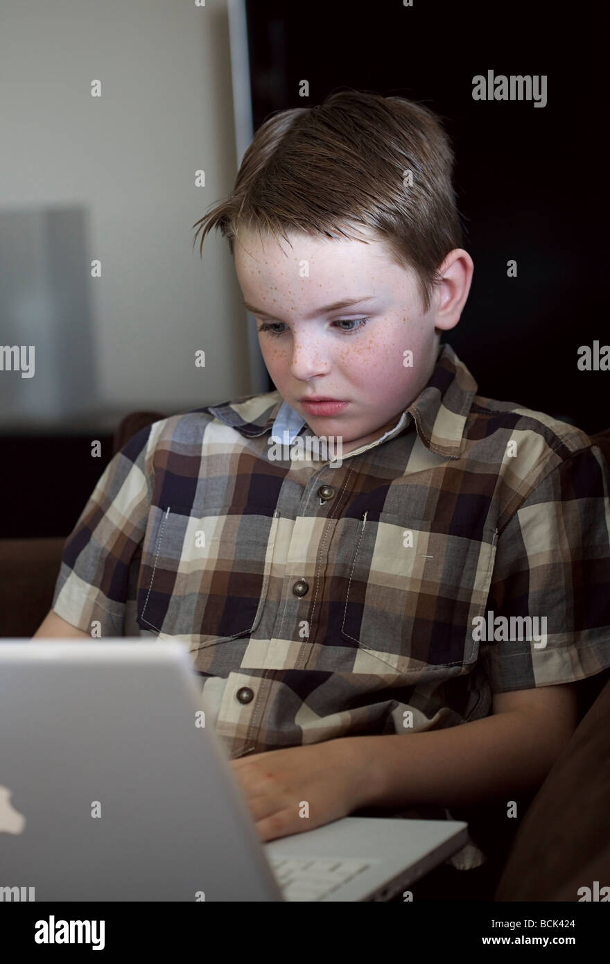 Young boy using laptop computer at home Stock Photo - Alamy