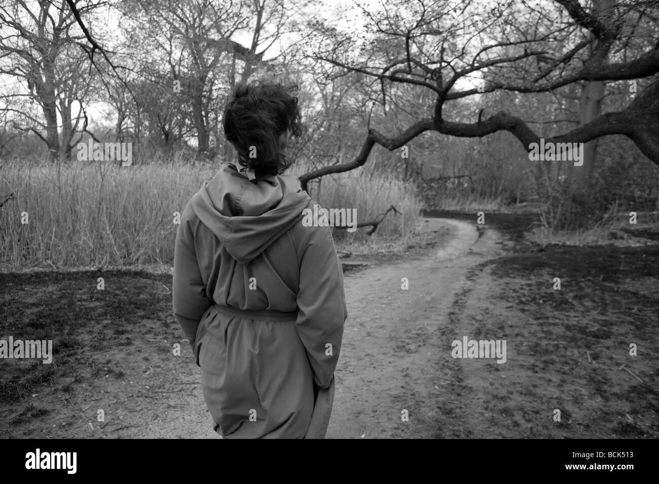 Woman walks alone in the early spring in Prospect Park Brooklyn NY ...