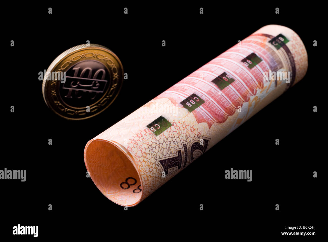 Kingdom of Bahrain Dinar currency banknotes roll and coin arranged on ...
