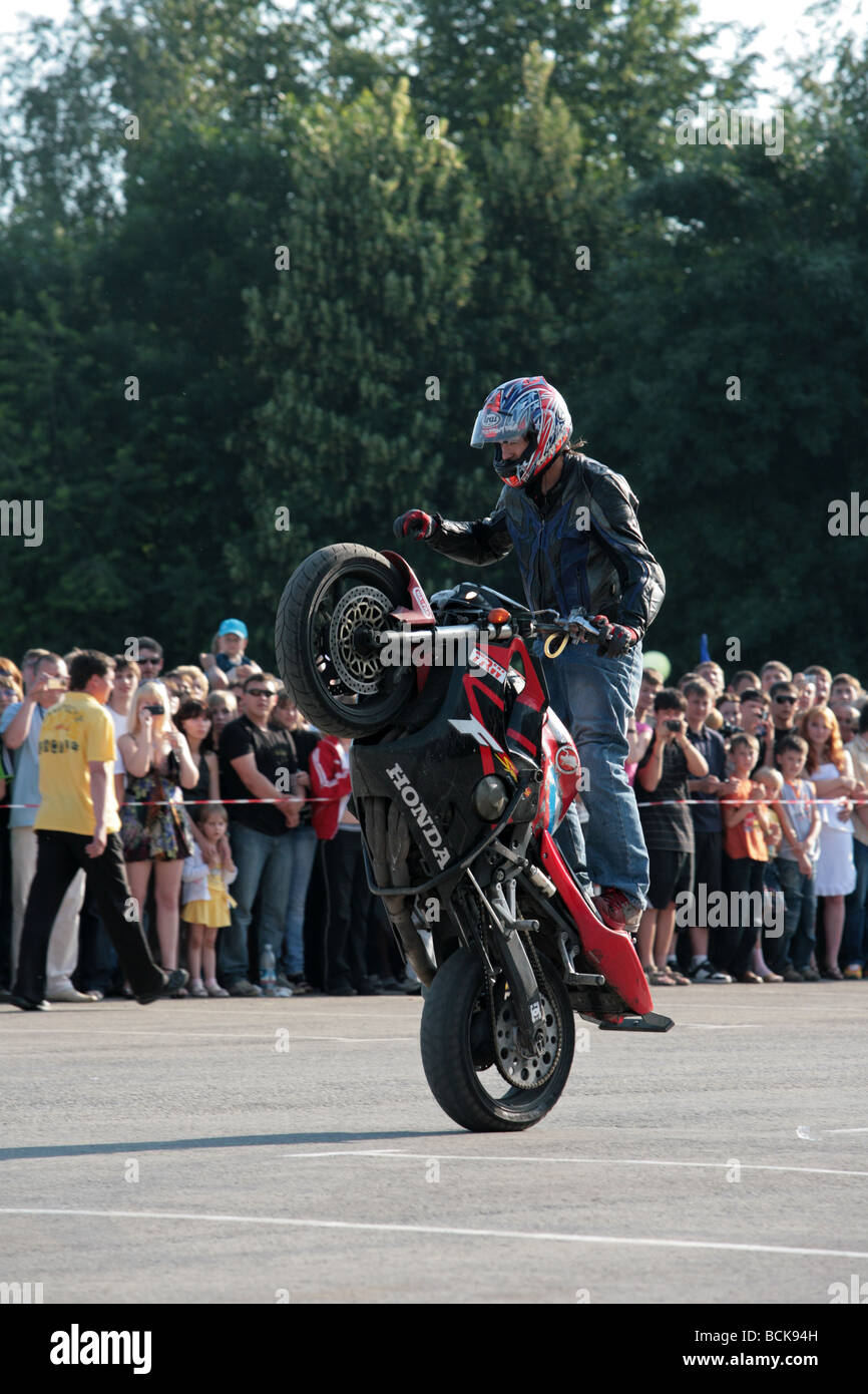 Streetbike freestyle stunt rider balancing on rear wheel Stock Photo ...
