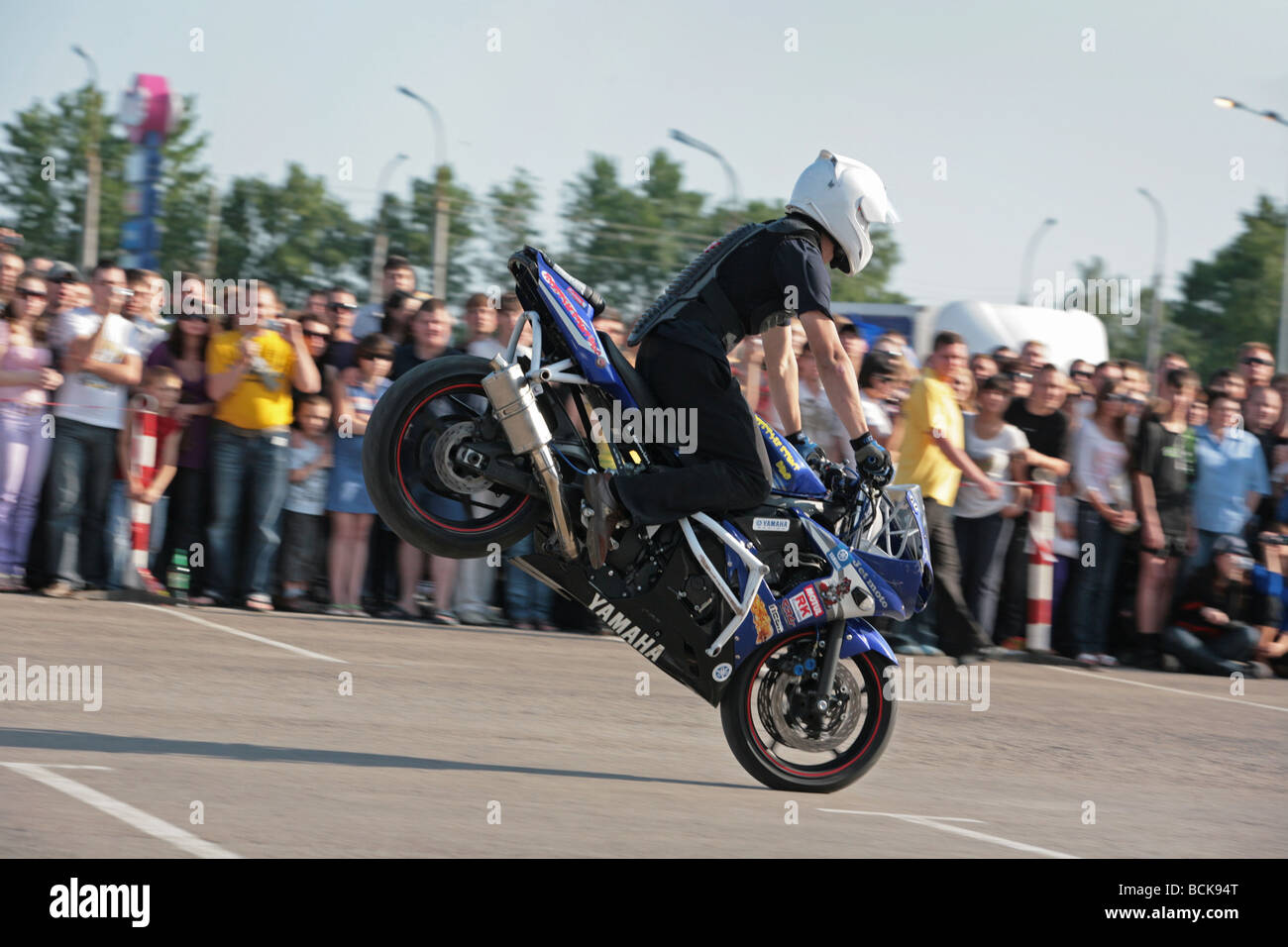 Streetbike freestyle stunt rider balancing on wheel Stock Photo - Alamy