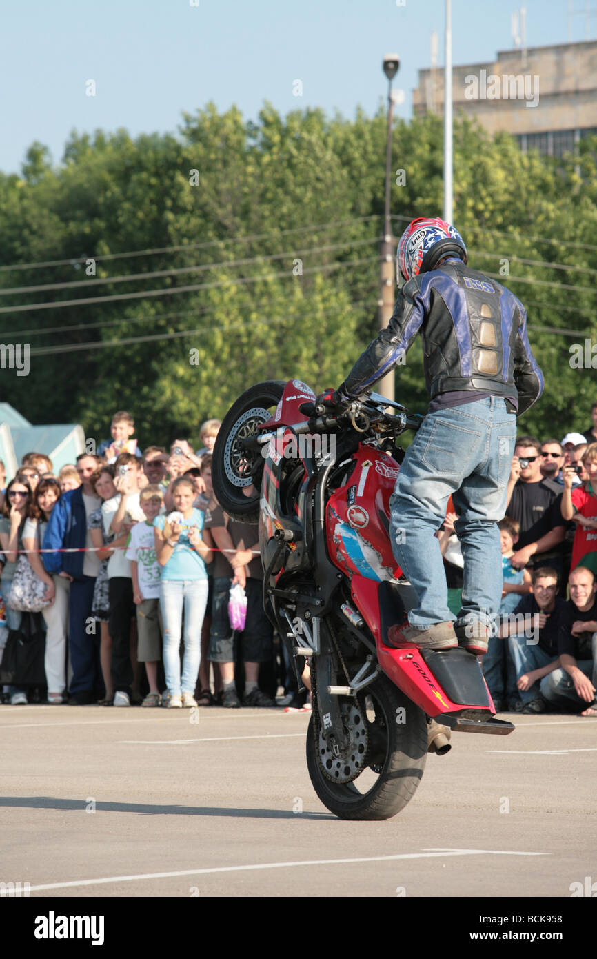 Streetbike freestyle stunt rider balancing on rear wheel Stock Photo ...