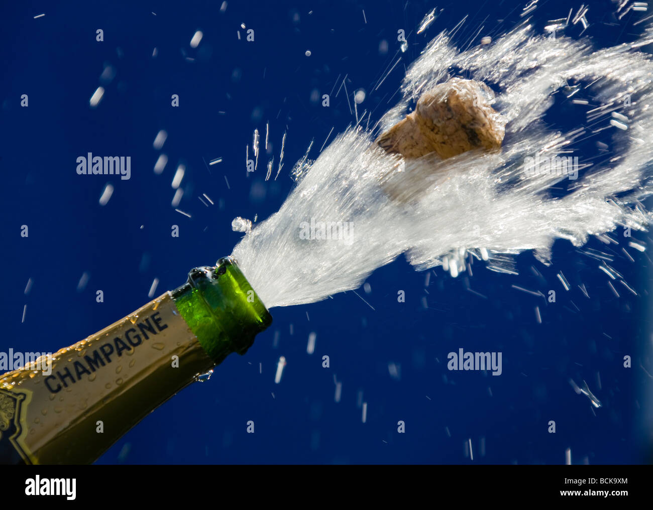 popping cork of an open champagne bottle Stock Photo - Alamy