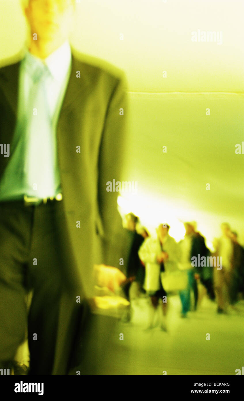 Businessman walking through concourse crowd hi-res stock photography ...