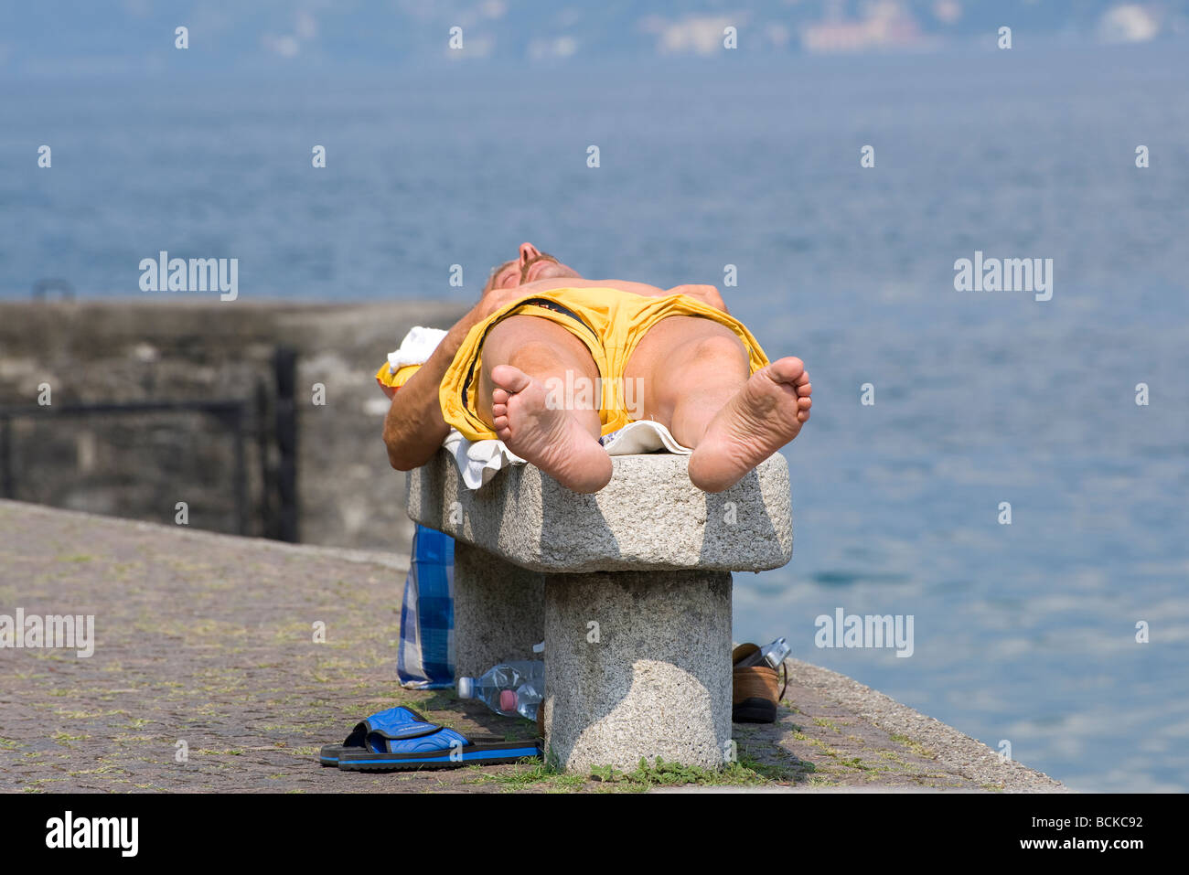 man sunbathing on park bench, menaggio, lake como, italy Stock Photo ...