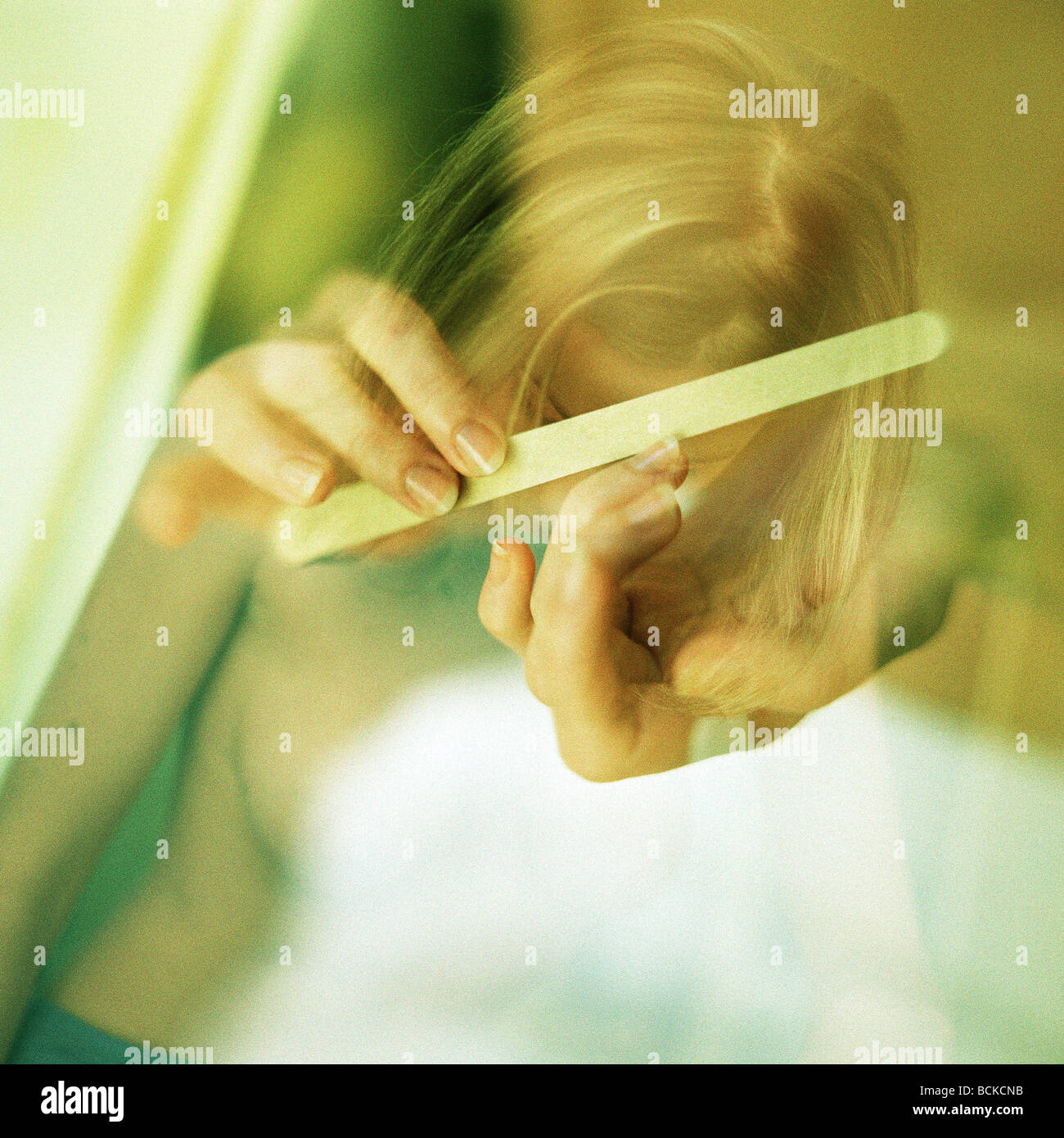 Woman filing nails Stock Photo - Alamy