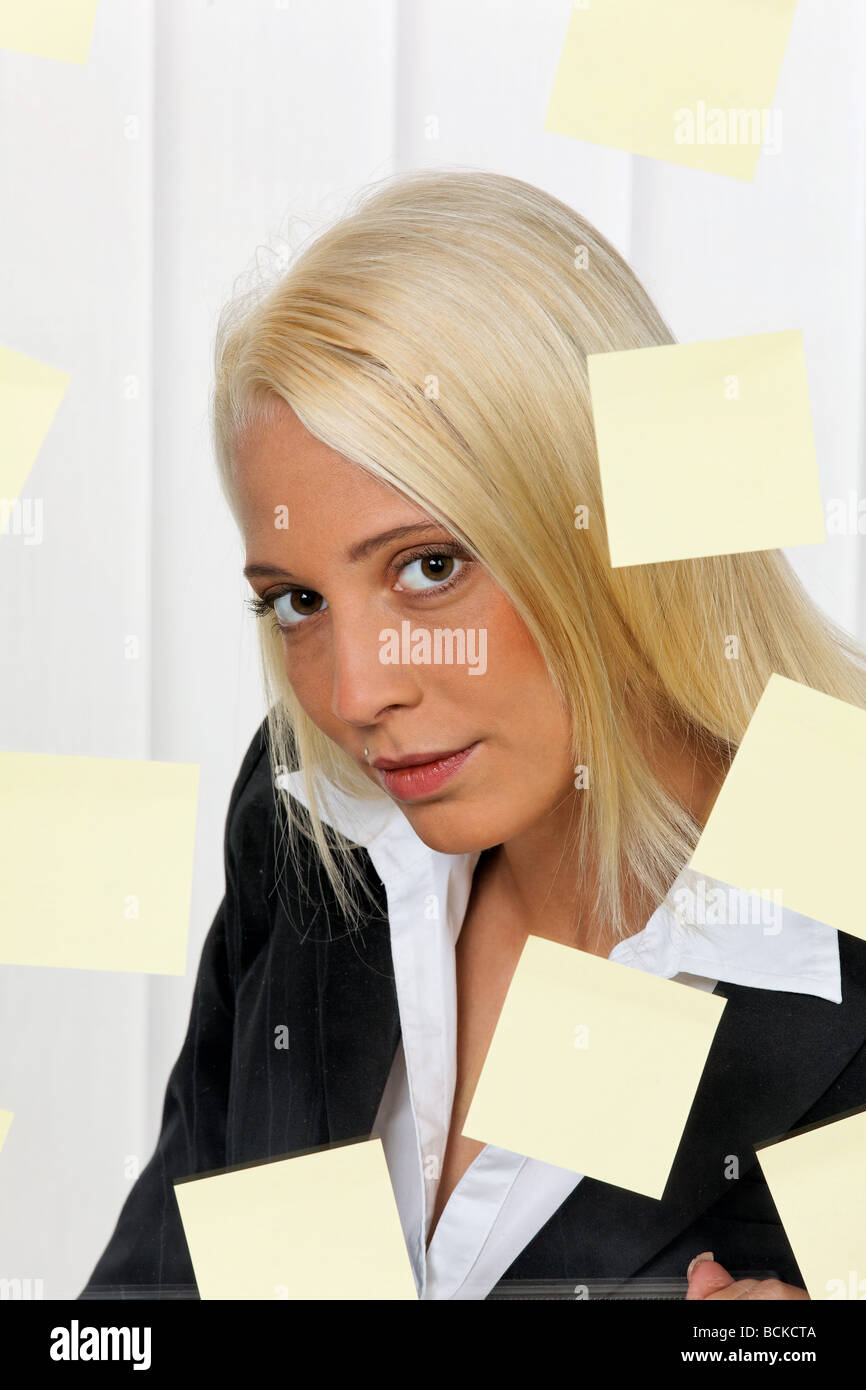 Young business woman with multiple tasks leaflets Stock Photo - Alamy