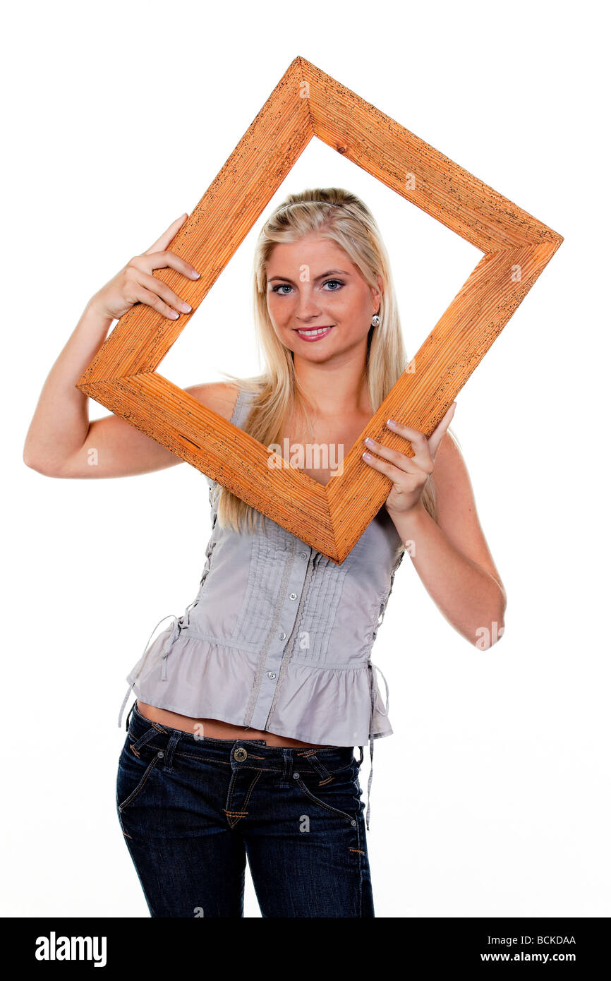 young woman looking through picture frame Stock Photo - Alamy
