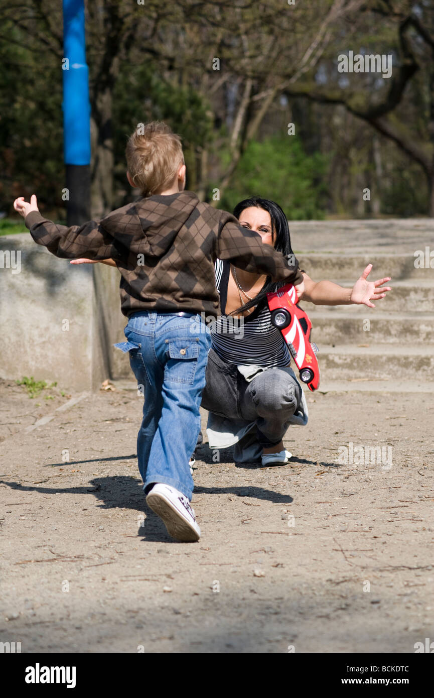 Boy running to mother Stock Photo - Alamy