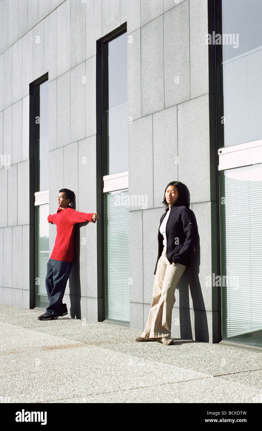 Urban scene, young people leaning against wall Stock Photo - Alamy