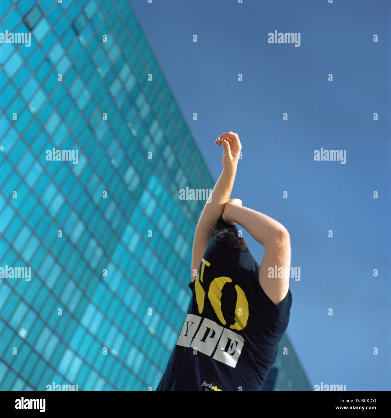 Urban scene, man taking off tee-shirt Stock Photo - Alamy