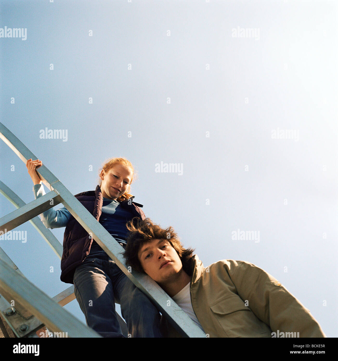 Young people on ladder, low angle view Stock Photo - Alamy