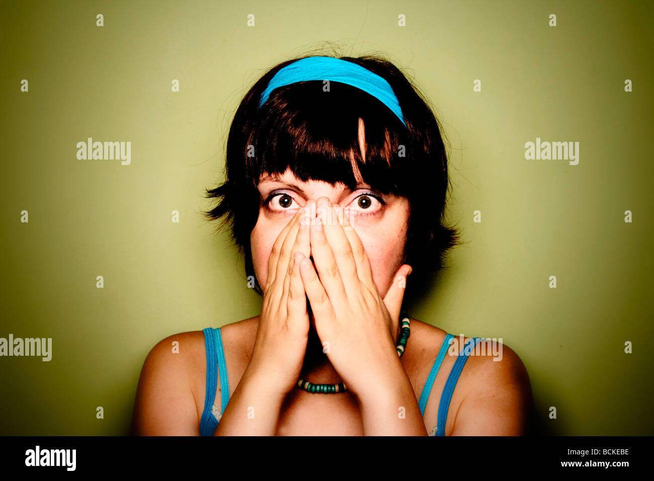 Woman holding back a sneeze with hand over nose Stock Photo - Alamy