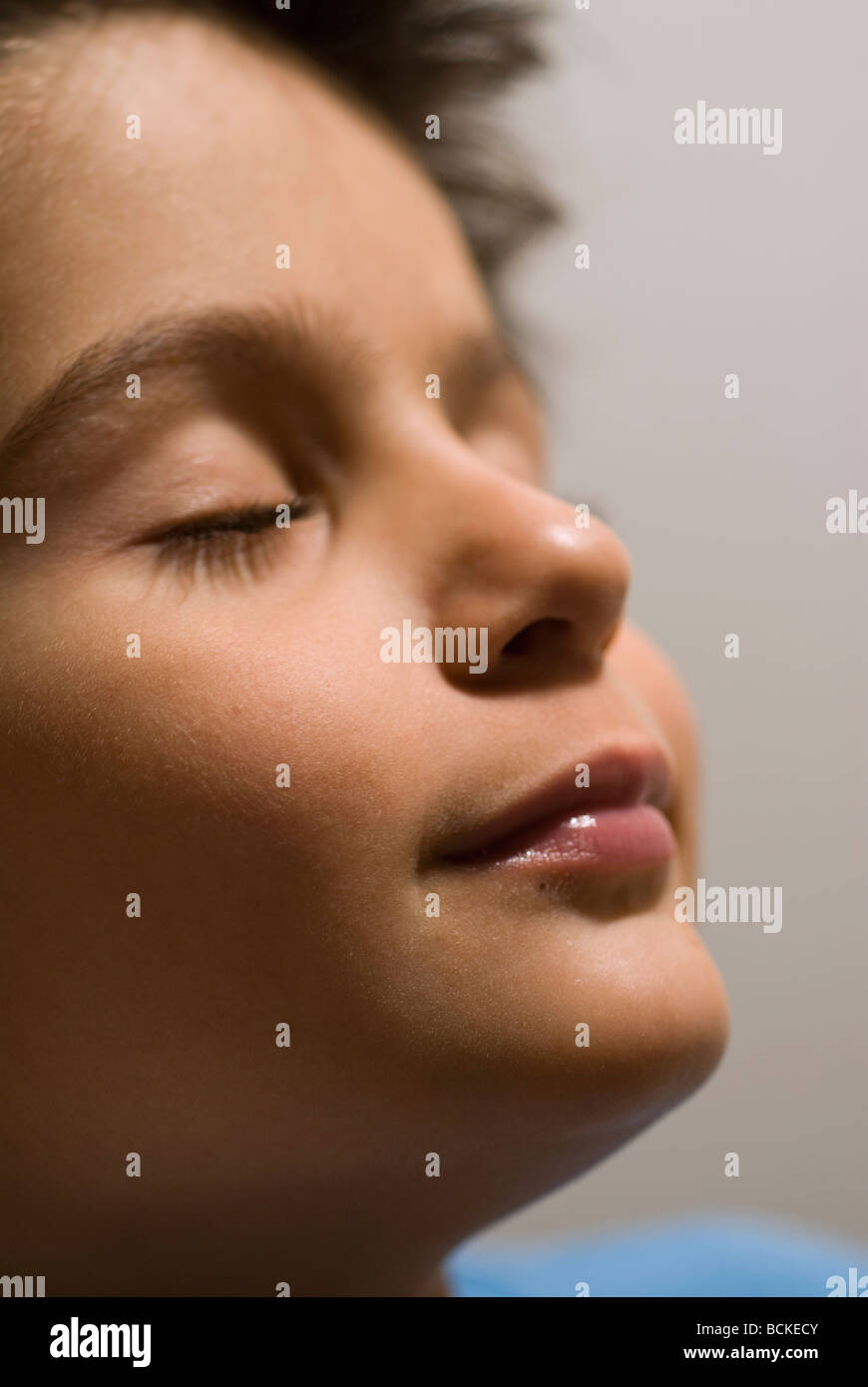 "Take a deep breath". A greek boy with closed eyes enjoying the fresh ...