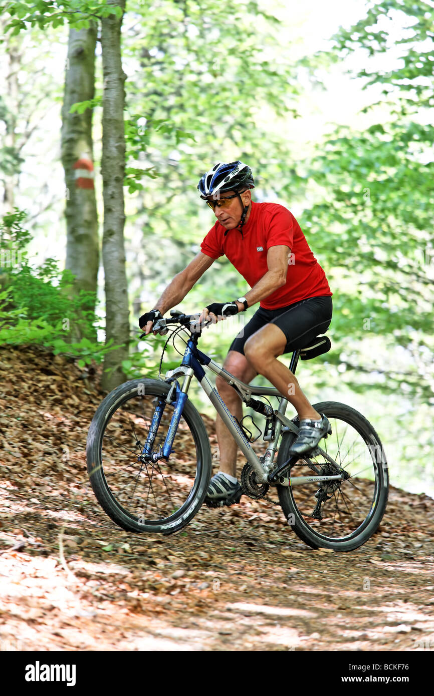 sporty senior with mountain bike in the woods Stock Photo - Alamy