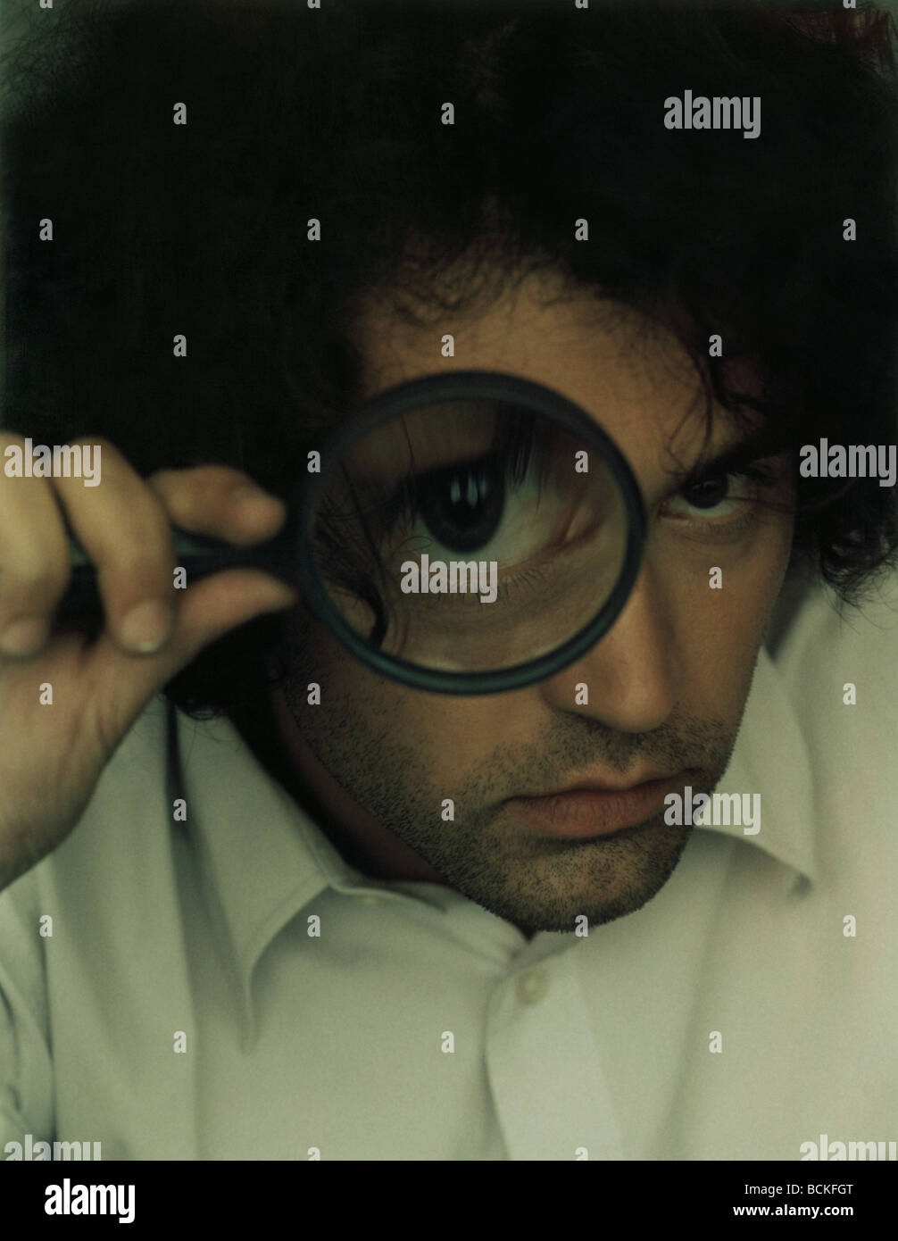 Man with magnifying glass Stock Photo - Alamy
