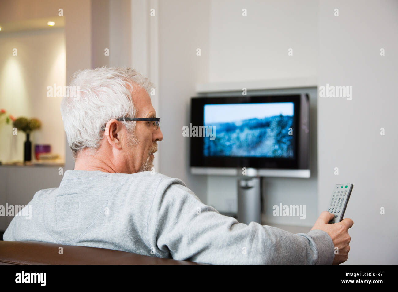 Mature man watching television Stock Photo - Alamy