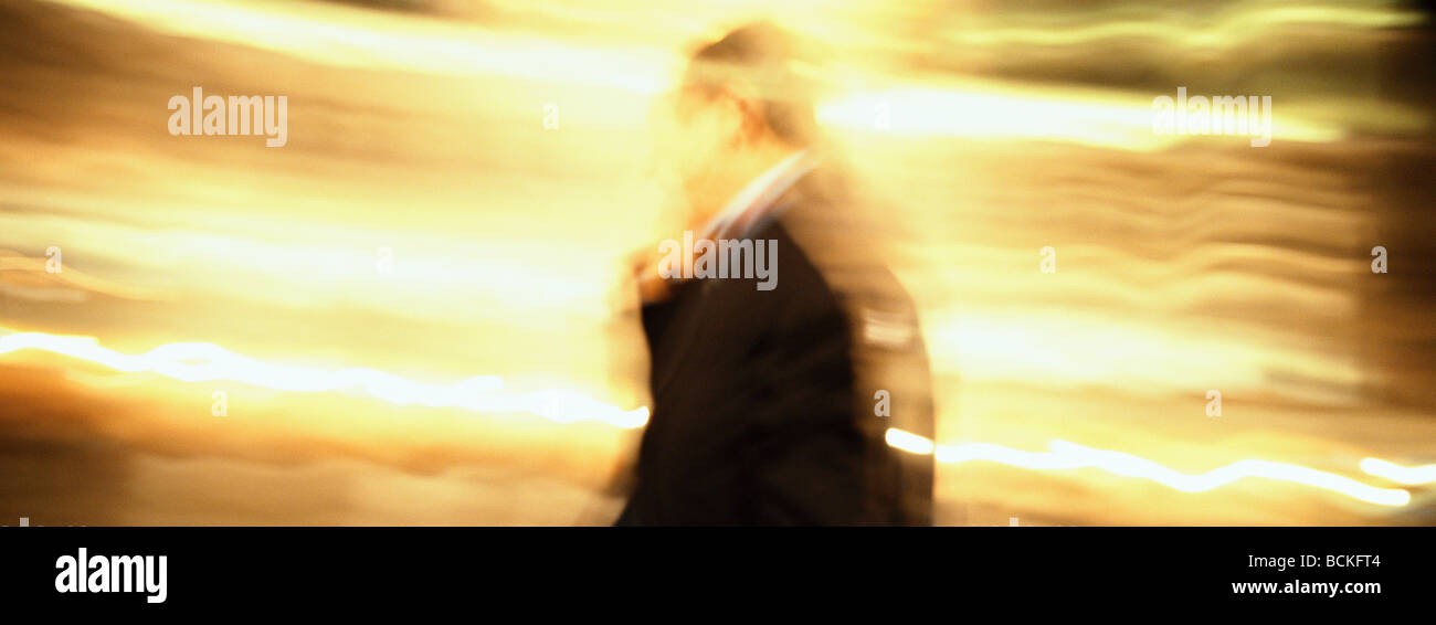 Person in front of light trails, panoramic view Stock Photo - Alamy