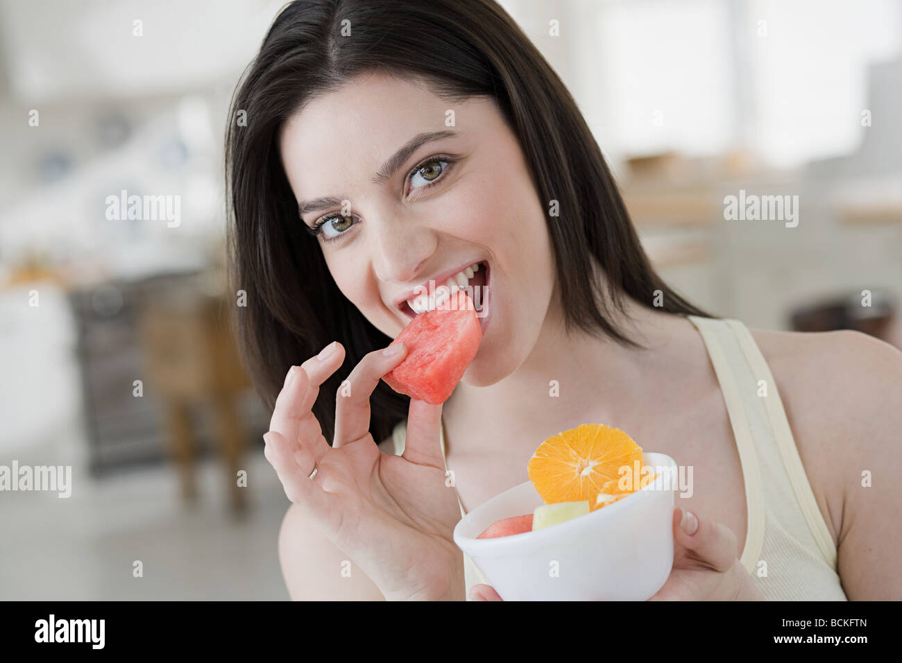 Young woman eating fruit Stock Photo - Alamy Young woman eating fruit Stock Photo - Alamy