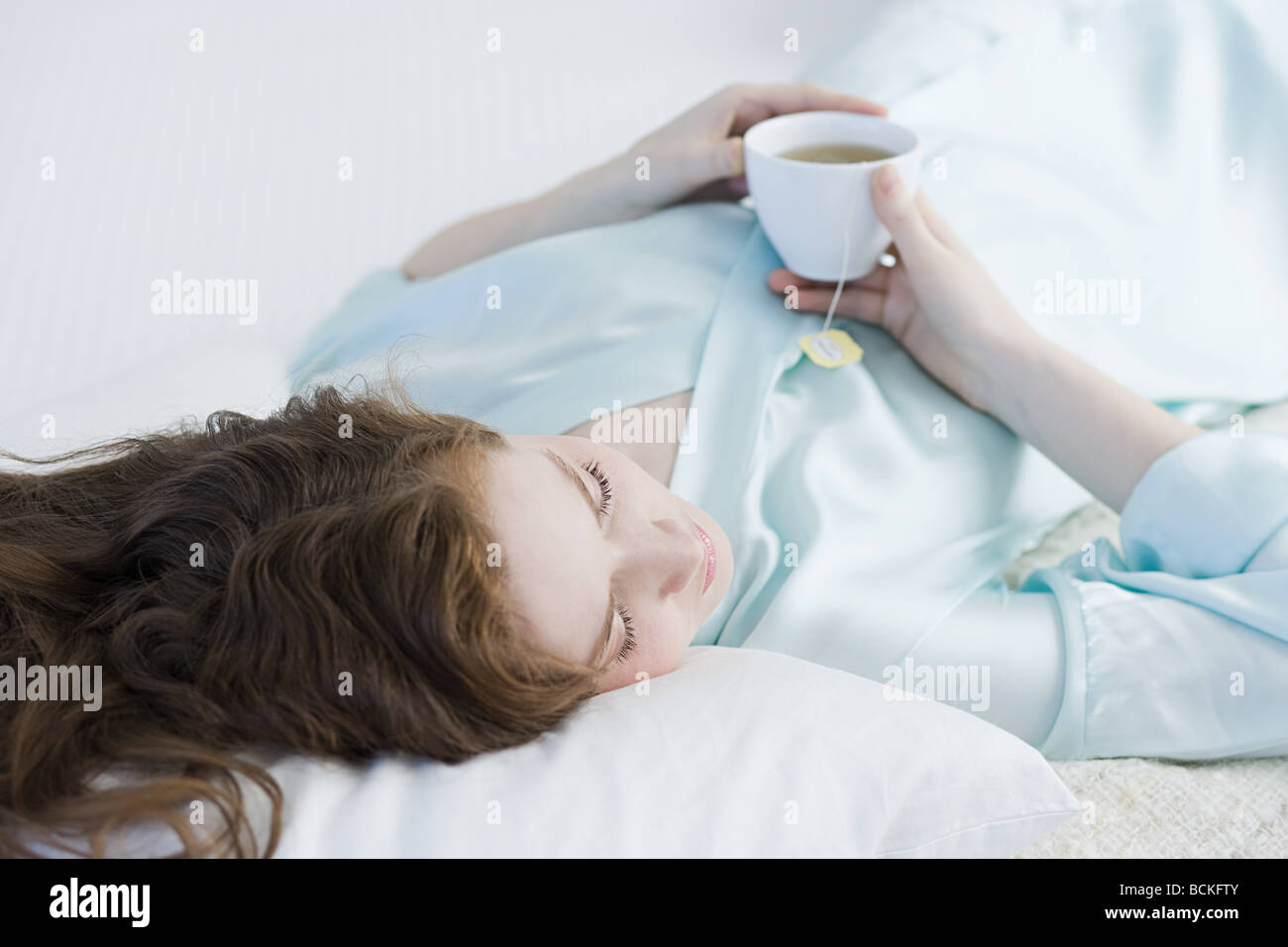 Woman relaxing with tea Stock Photo - Alamy