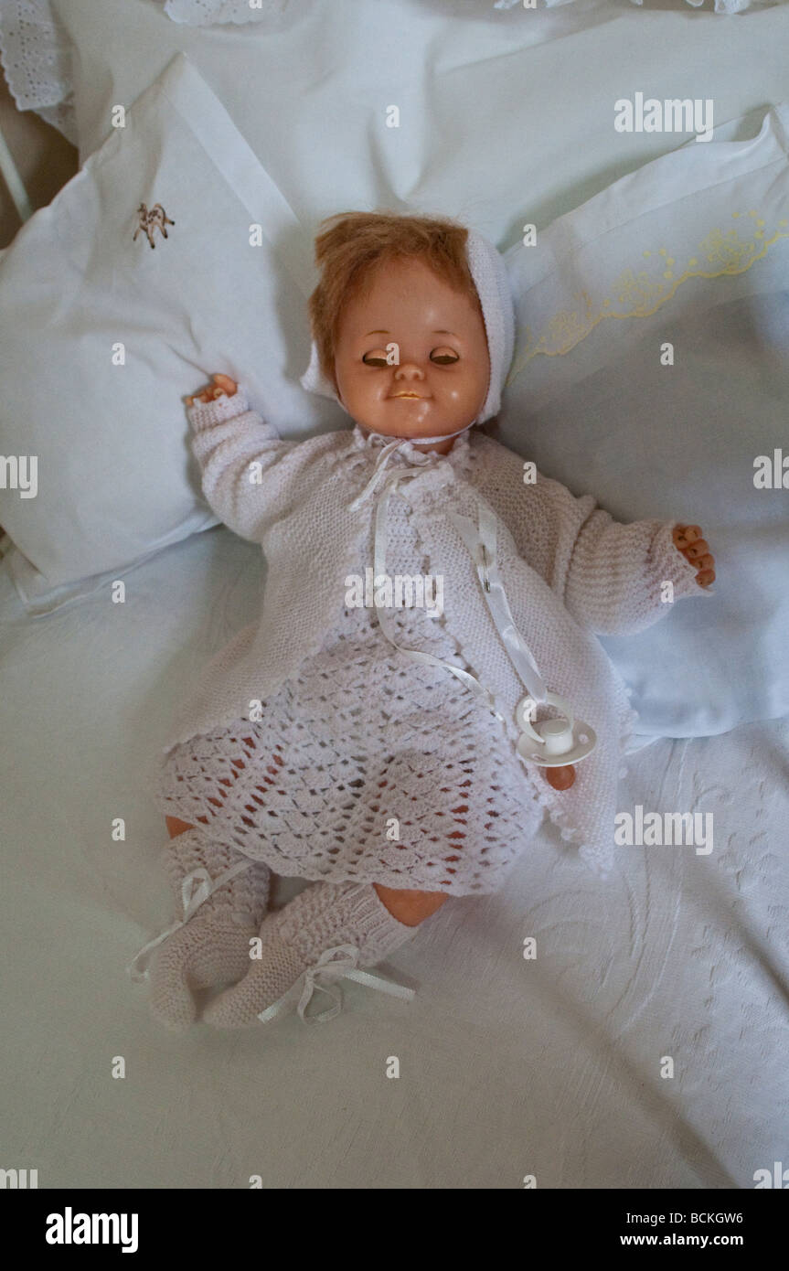 Doll sleeping on a white bed Stock Photo - Alamy